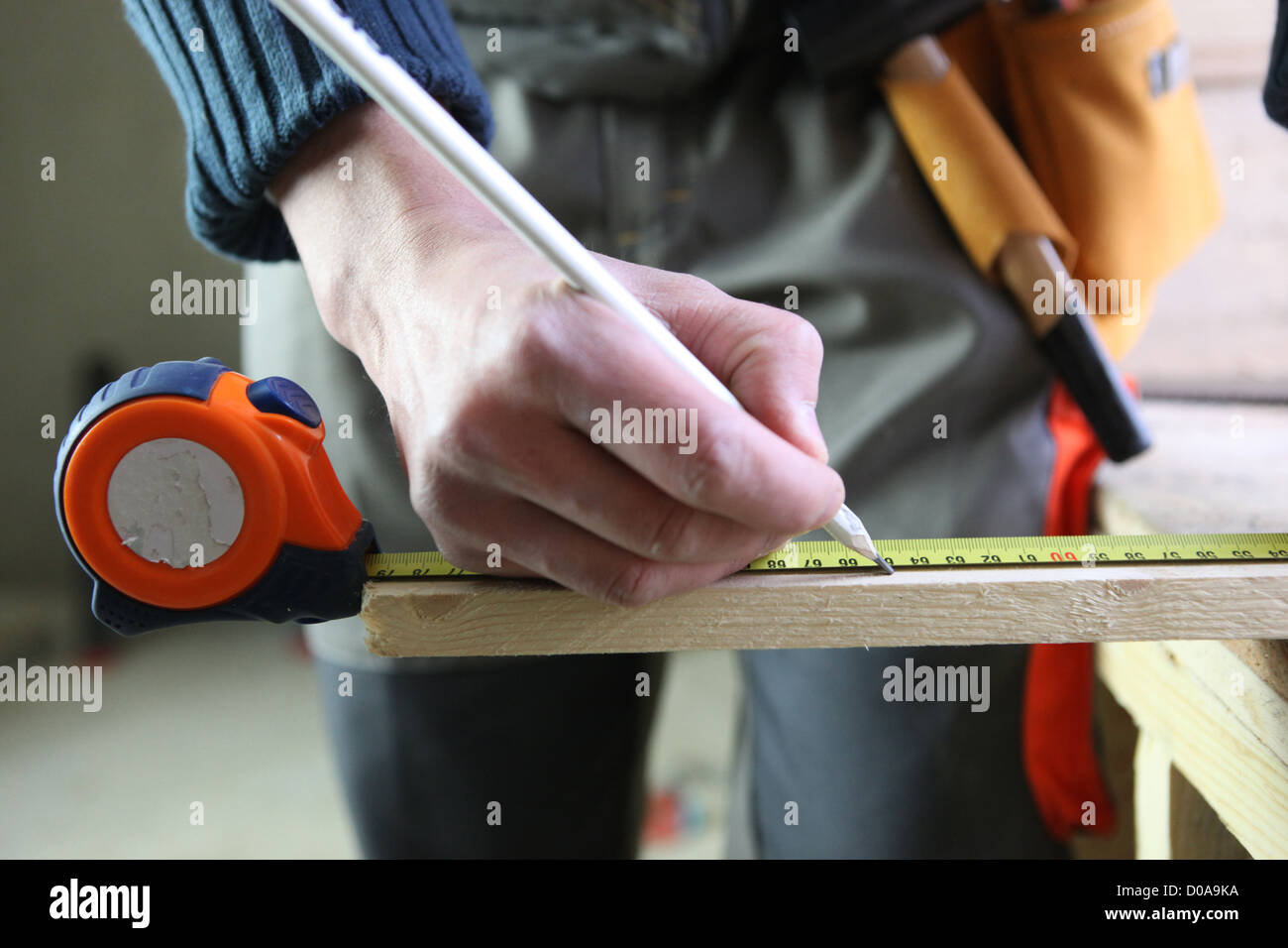 Carpenter marking a piece of wood Stock Photo - Alamy
