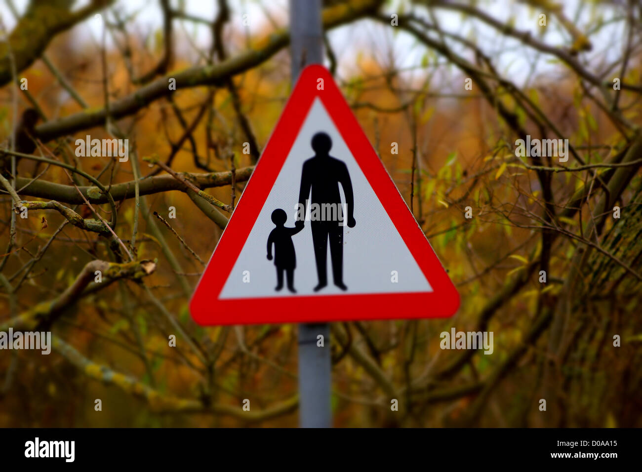Warning sign children and adults crossing Stock Photo - Alamy