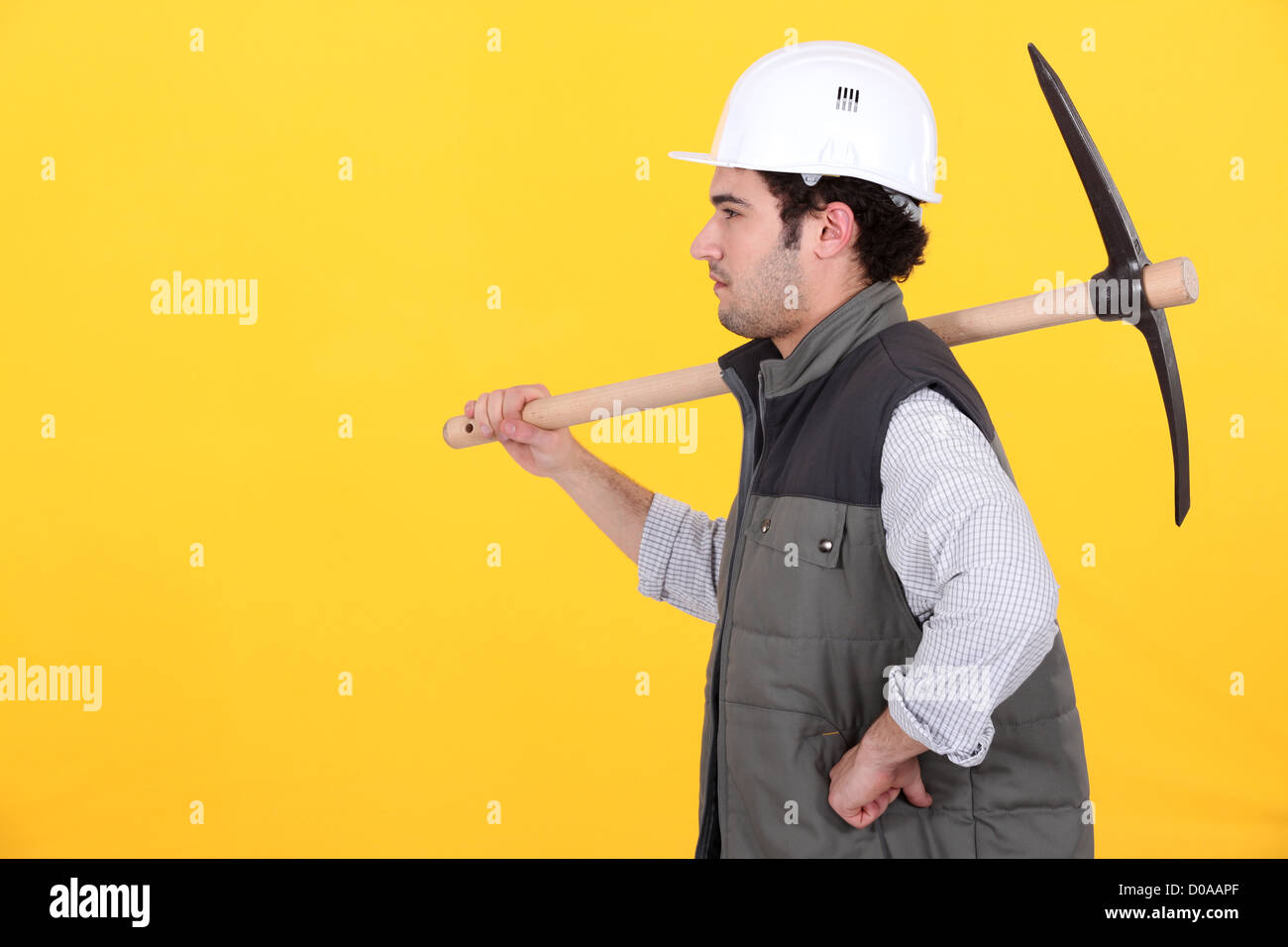 Profile of man with pick-axe Stock Photo - Alamy