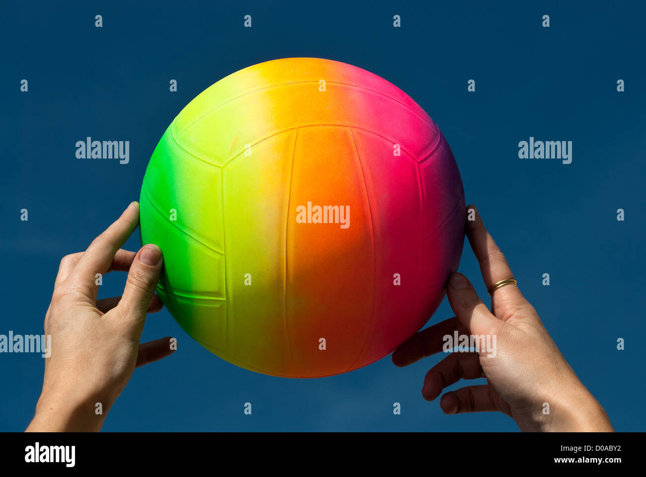 hands holding a ball with the colors of the rainbow Stock Photo - Alamy