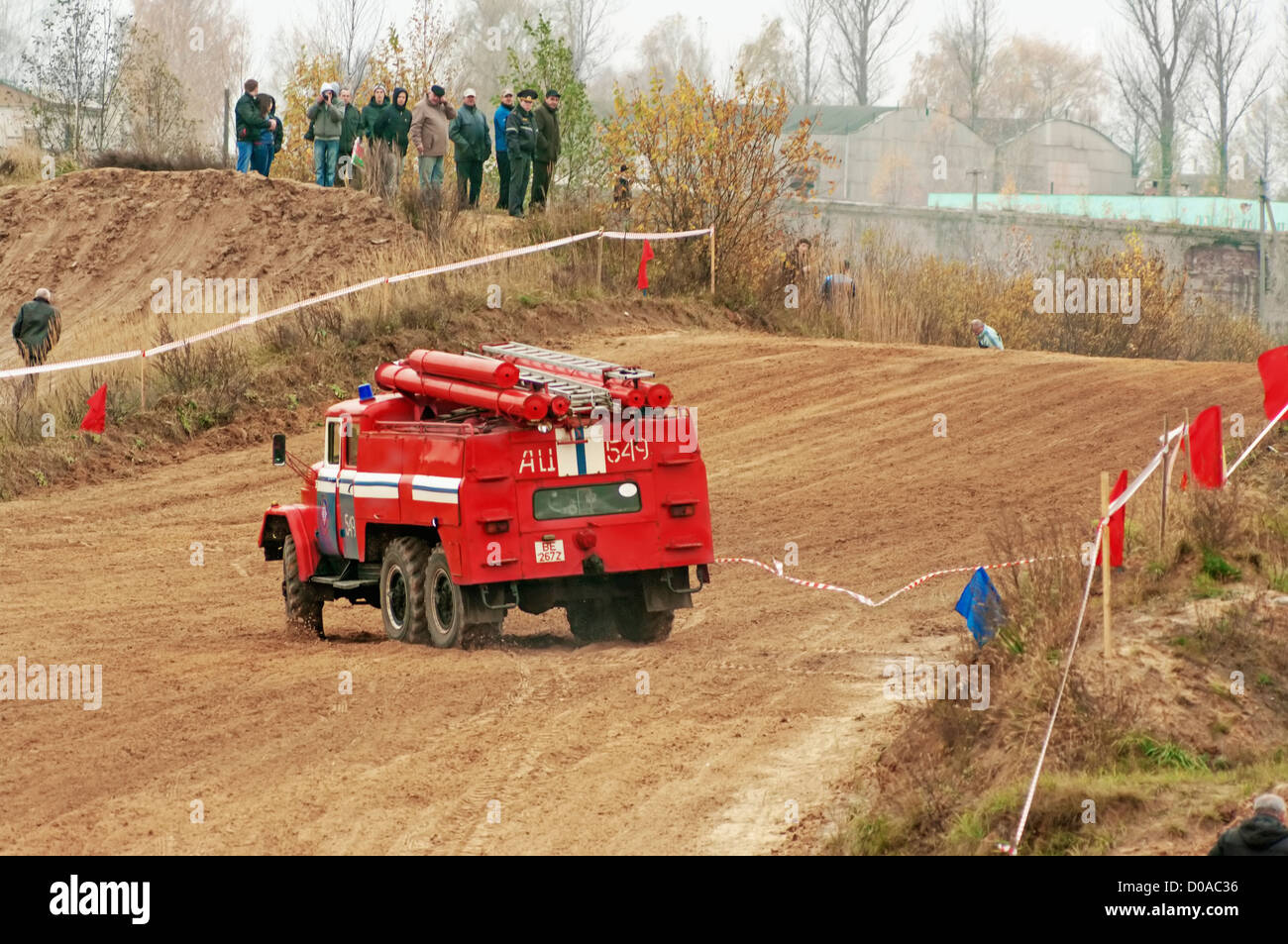 The fire truck goes on a fire of the racing car Stock Photo - Alamy