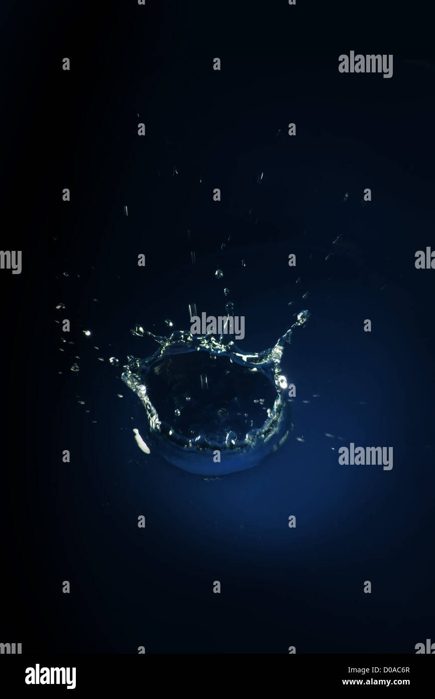Water splash over dark blue background Stock Photo - Alamy