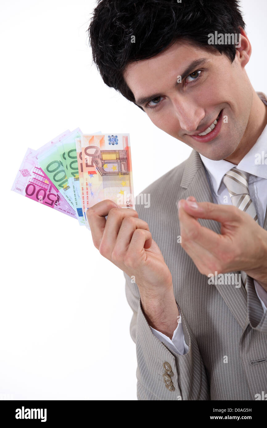 Rich businessman showing off his money Stock Photo - Alamy