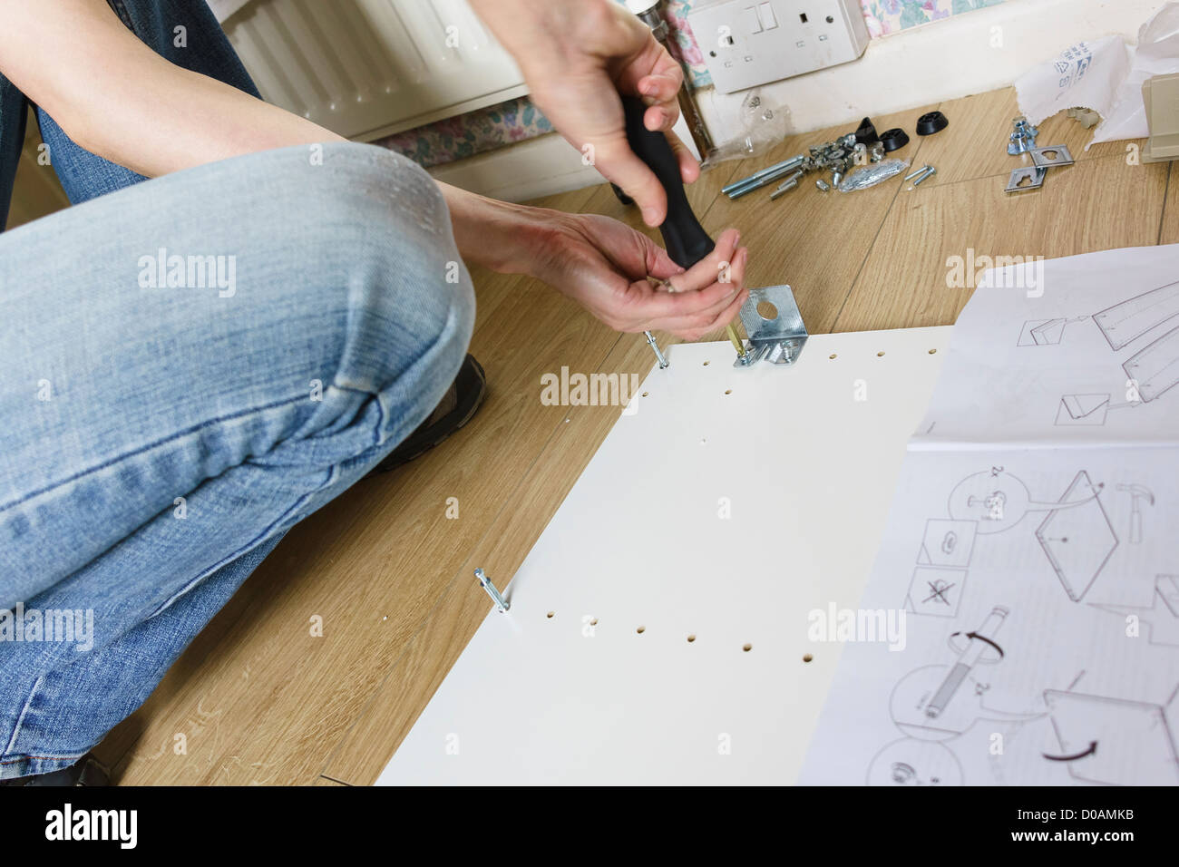 DIY. A woman assembling IKEA flat pack furniture Stock Photo - Alamy