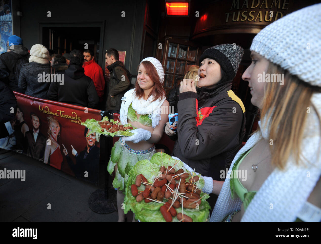 PETA protesters hand out vegetarian sausages during the Lady Gaga ...