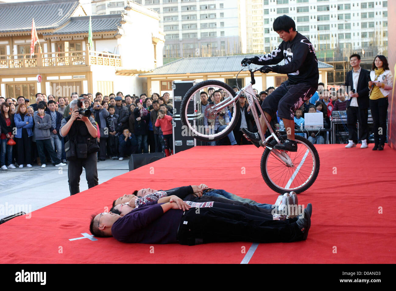 A man performs a stunt on a bicycle during a Superman Competition in Xi ...