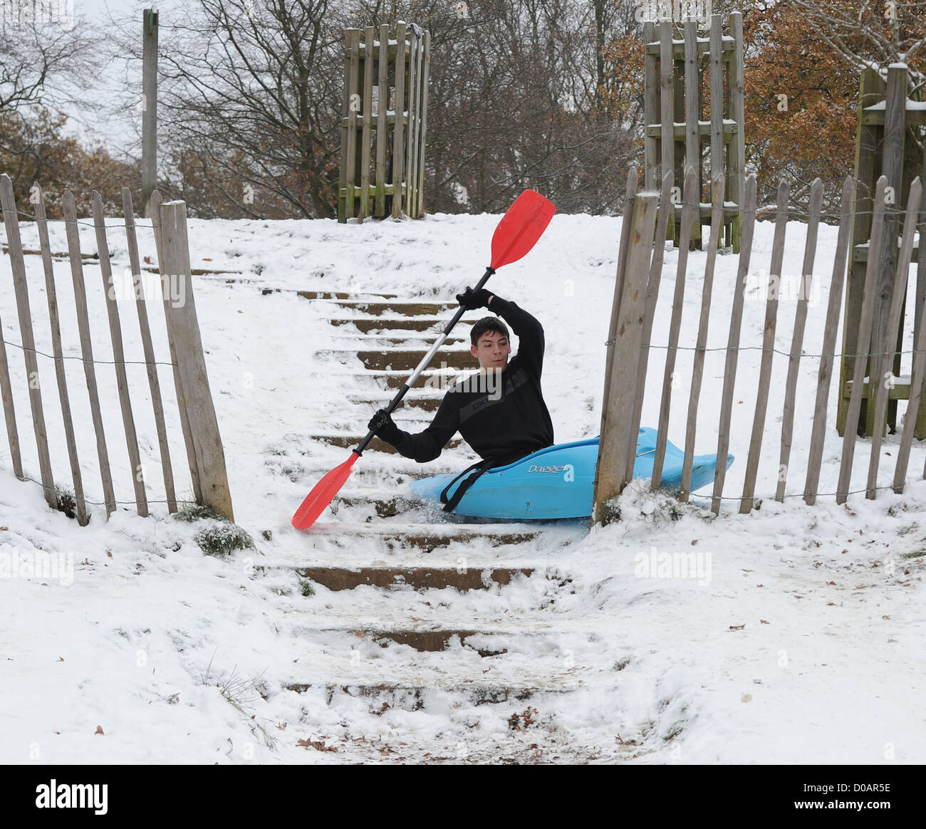 A man practicing his kayaking skills down some snow covered stairs in ...
