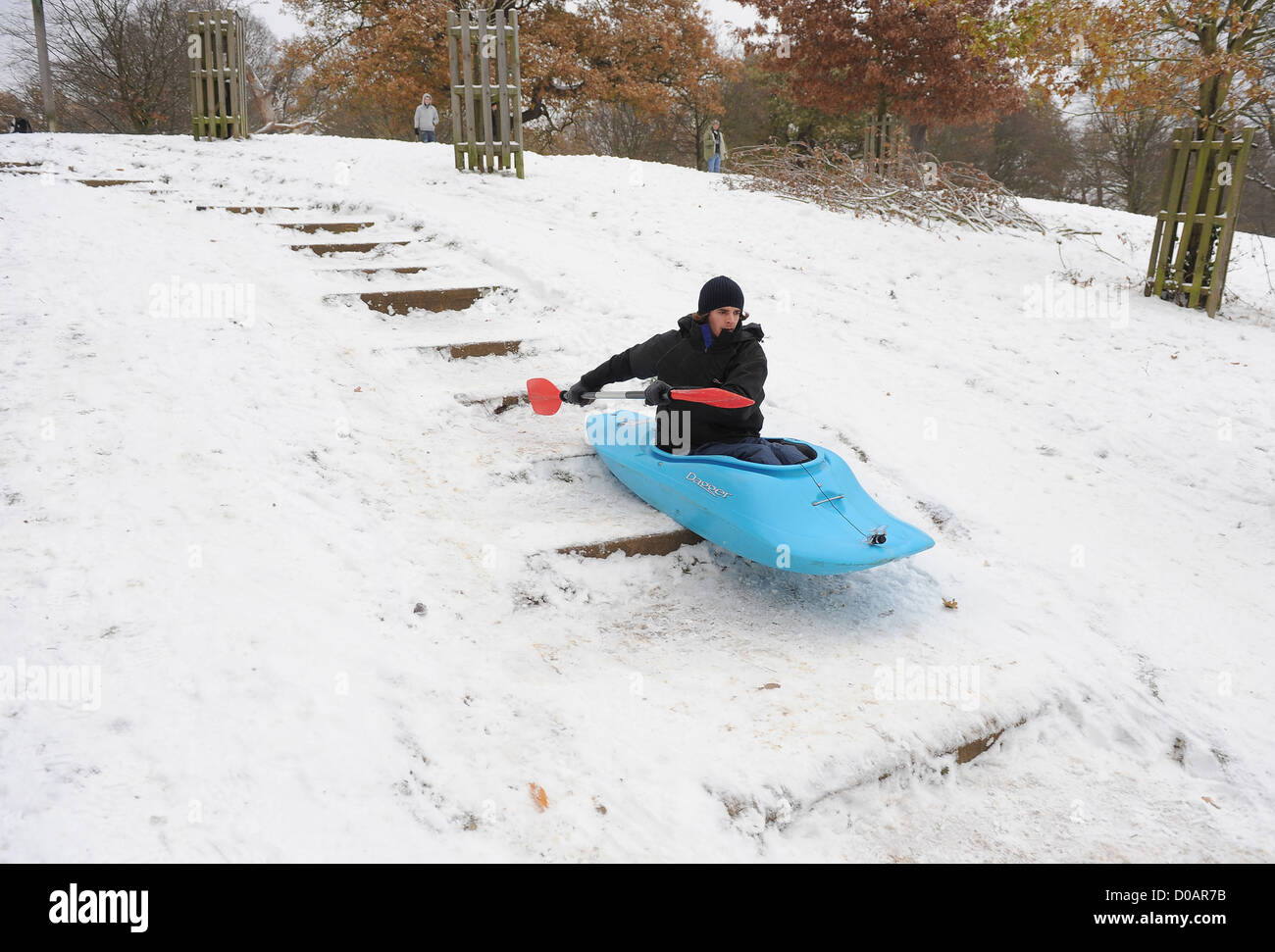 A man practicing his kayaking skills down some snow covered stairs in ...