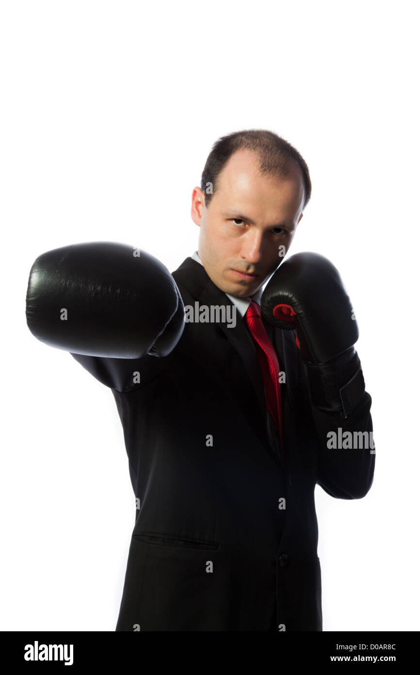 Businessman with a tie and boxing gloves punching, vertical shot ...