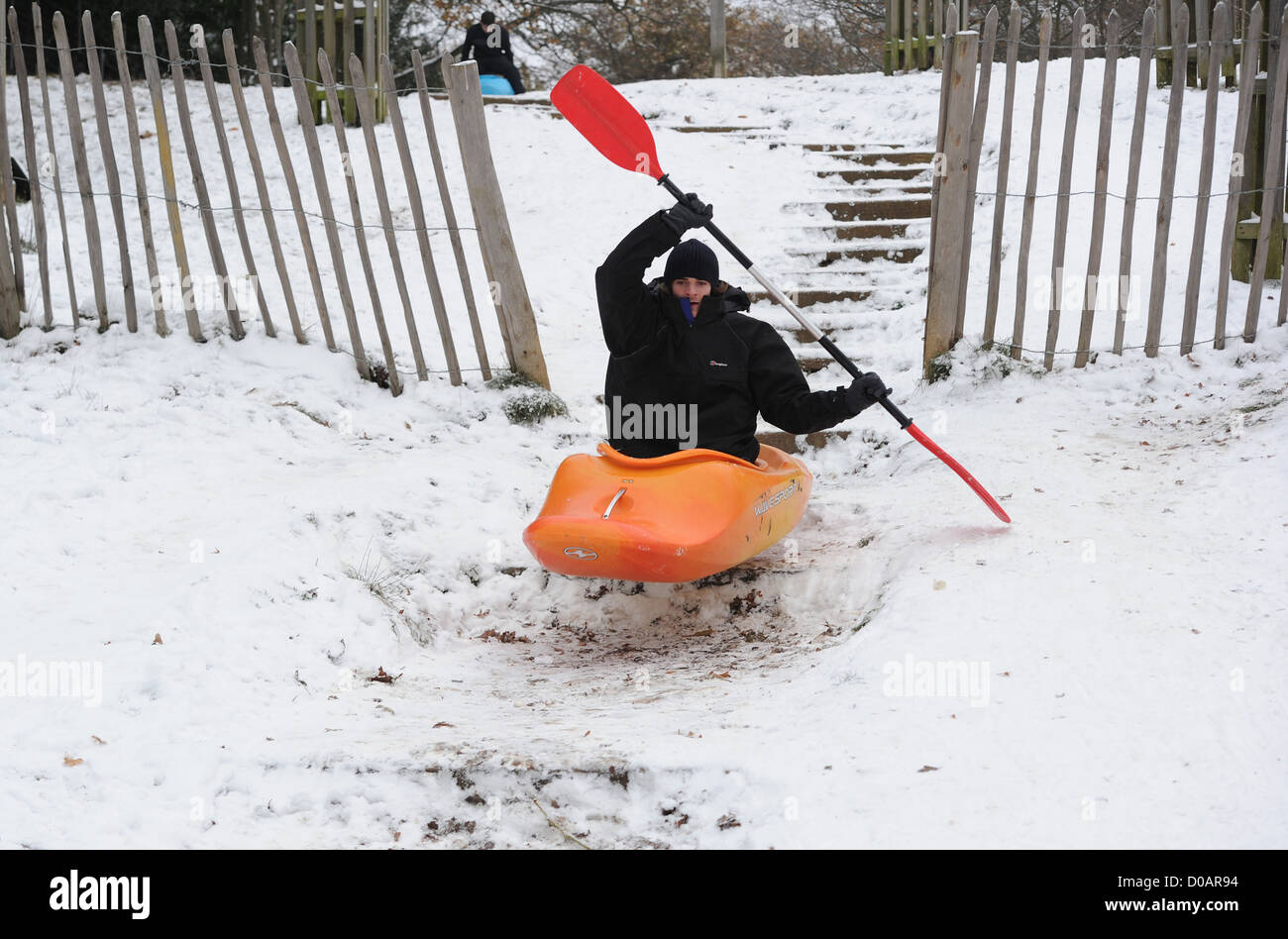 A man practicing his kayaking skills down some snow covered stairs in ...