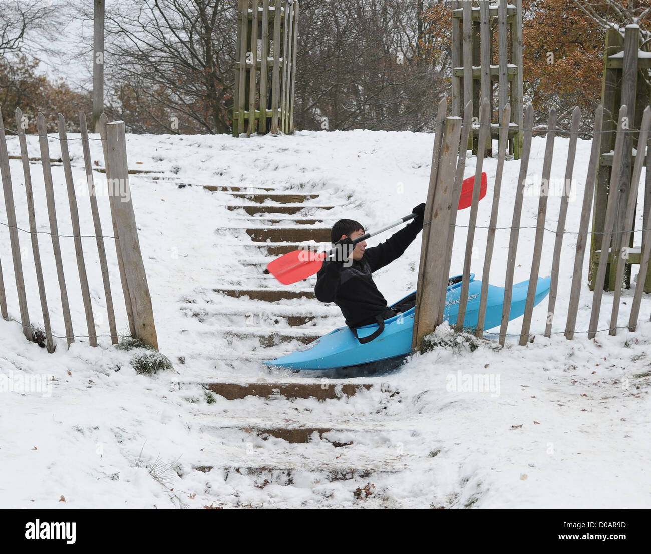 A man practicing his kayaking skills down some snow covered stairs in ...