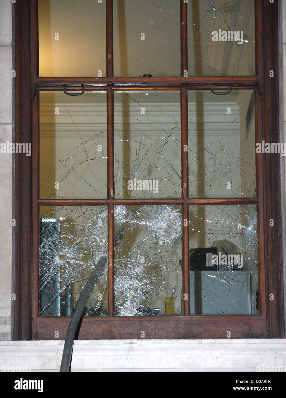 A smash window with an iron bar as students protest against an increase ...