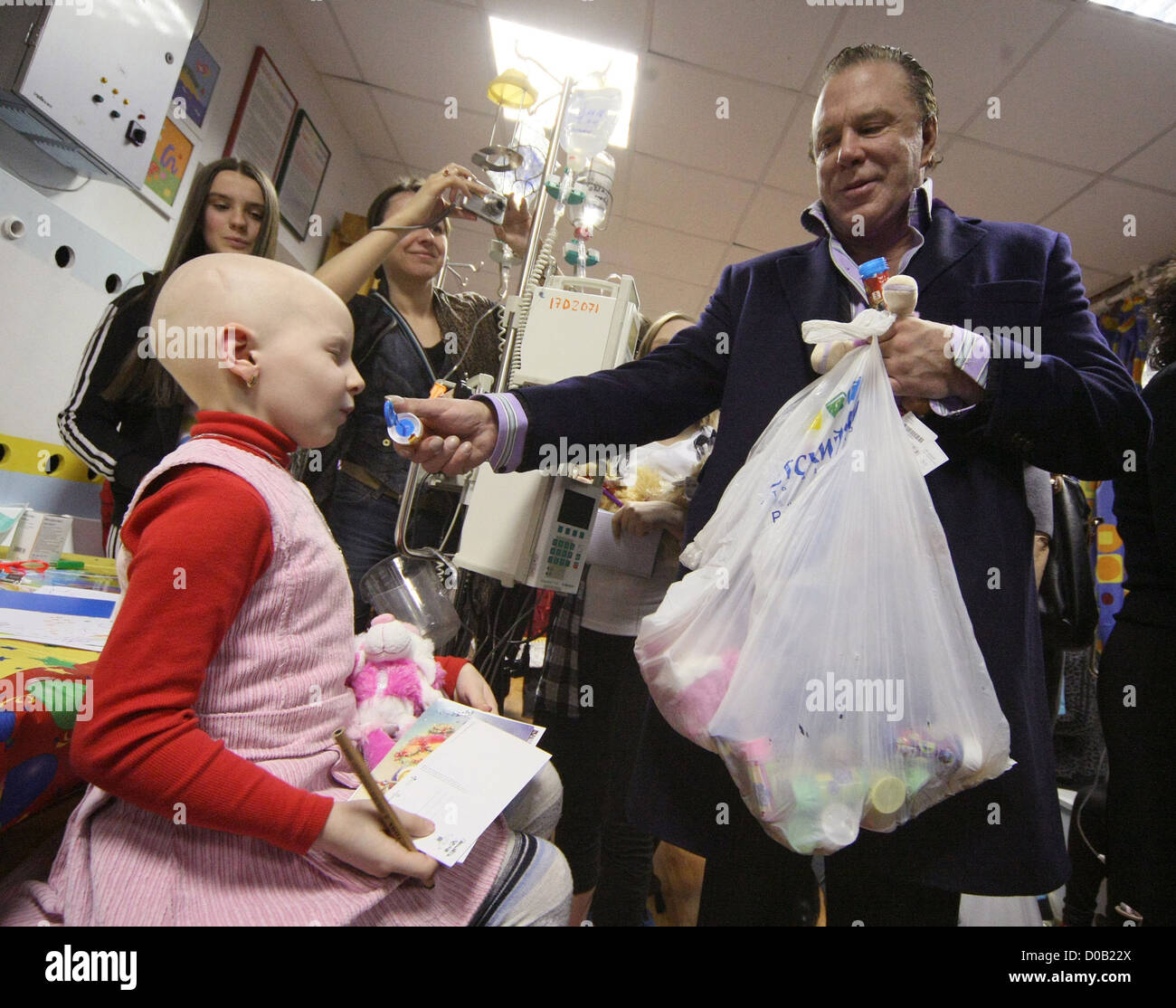 Mickey Rourke hands out gifts during his visit to a children's hospital ...