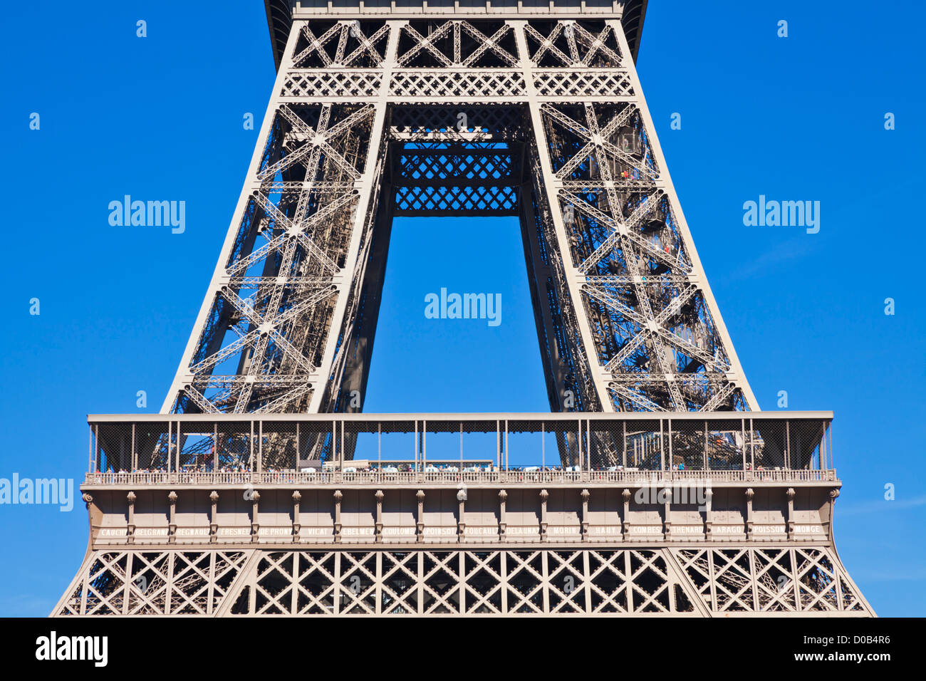 The Eiffel tower close up of the framework against a blue sky [no ...