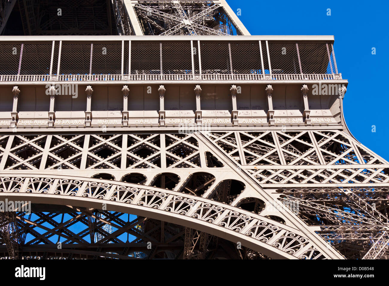 The Eiffel tower close up of the framework against a blue sky [no ...
