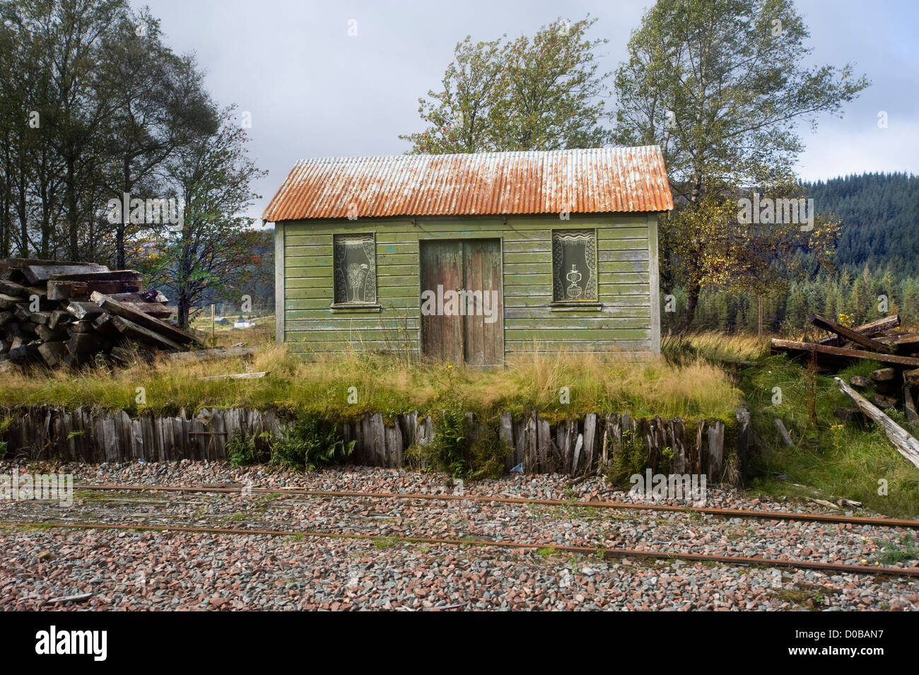 A railway track platelayers hut with windows painted wih lace curtains ...