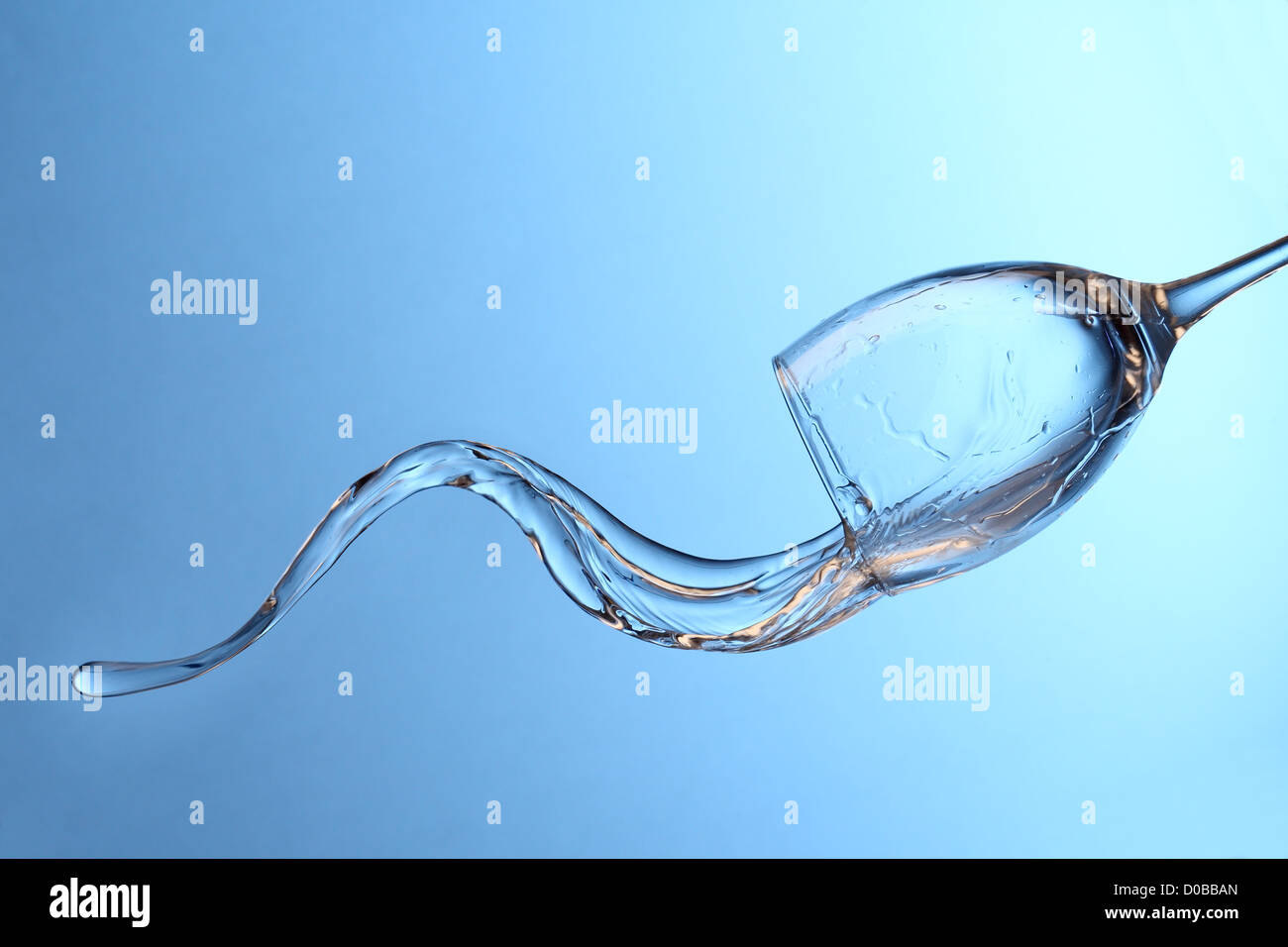 Water splashes out of water glass Stock Photo - Alamy
