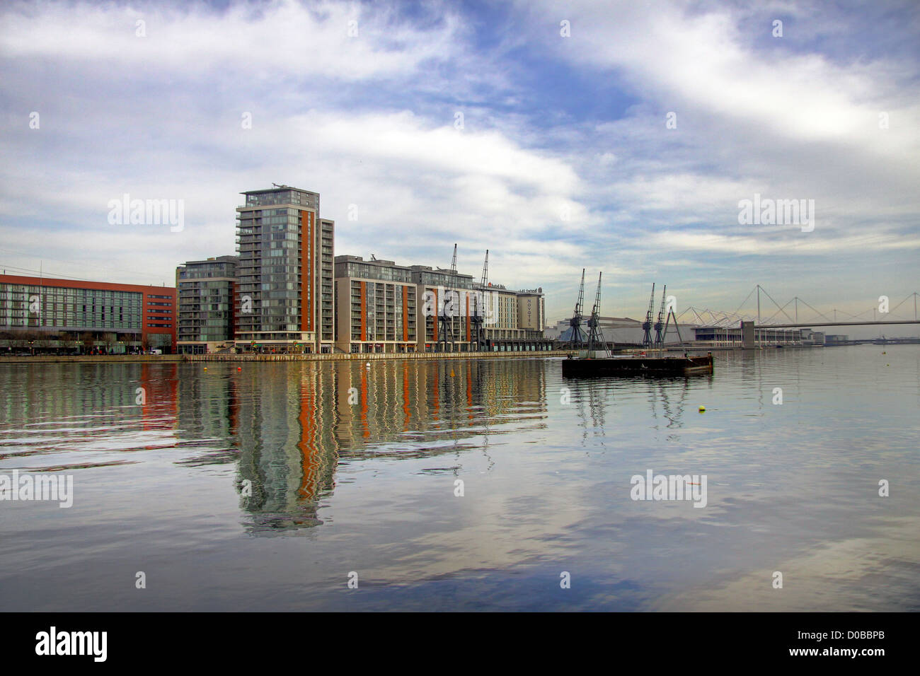 Reflective view across Royal Victoria Docks, Silvertown, London, UK ...