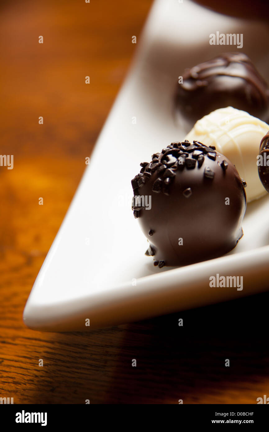 Chocolate truffles on plate, vertical Stock Photo - Alamy