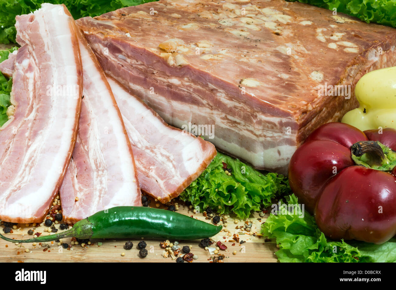 Still life with sliced romanian bacon and vegetables Stock Photo - Alamy