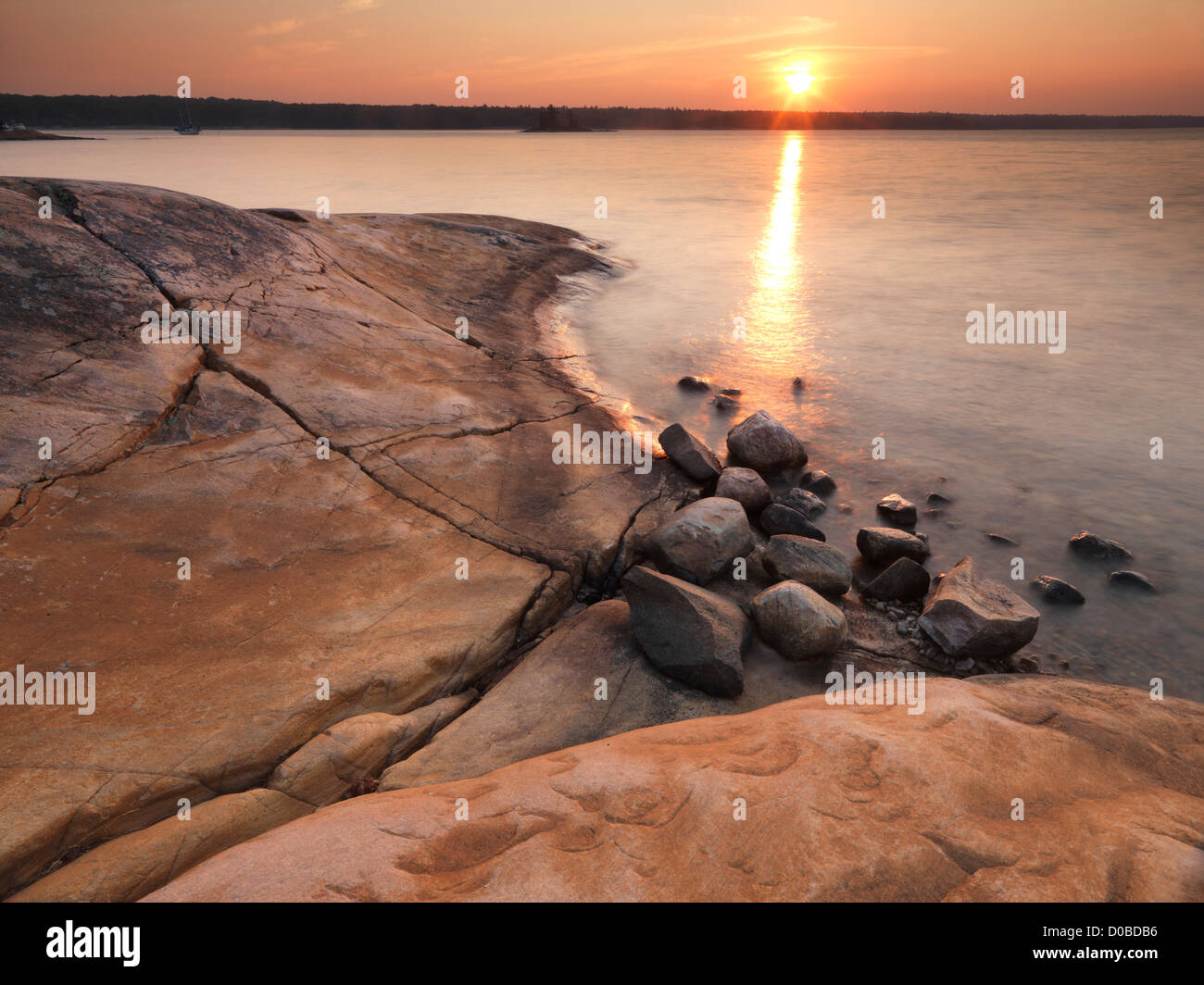 Red sunrise landscape nature scenery of rocks on a shore of Georgian ...