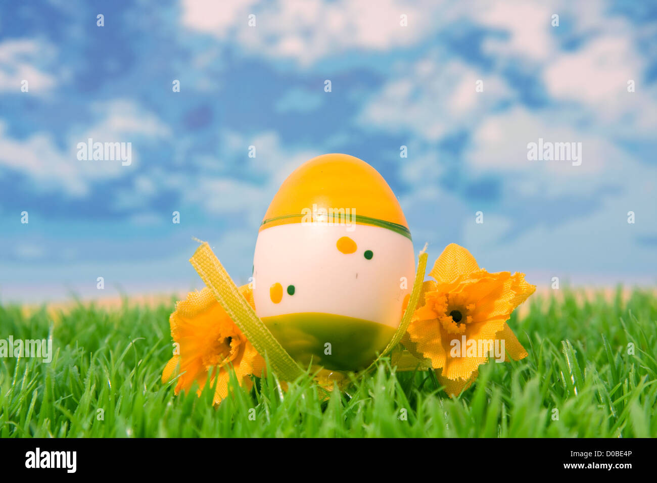 Easter egg on grass with flowers Stock Photo - Alamy