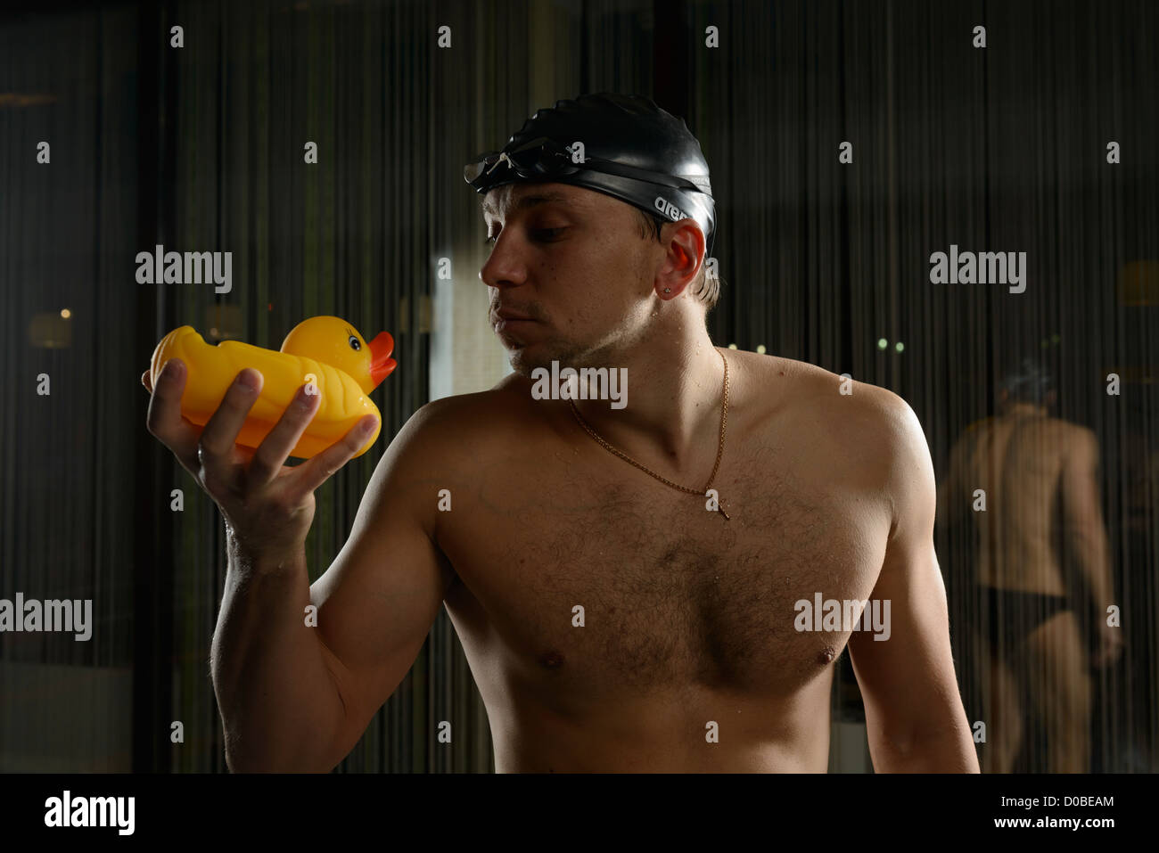 rubber yellow duck swimming pool swimmer young man male Stock Photo - Alamy