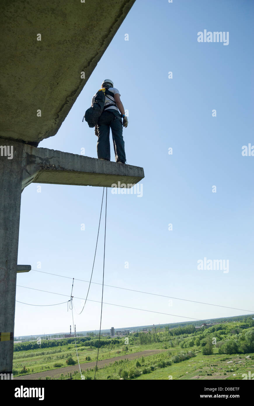 ropejumper standing jumping edge building tall extreme sports risk rope ...