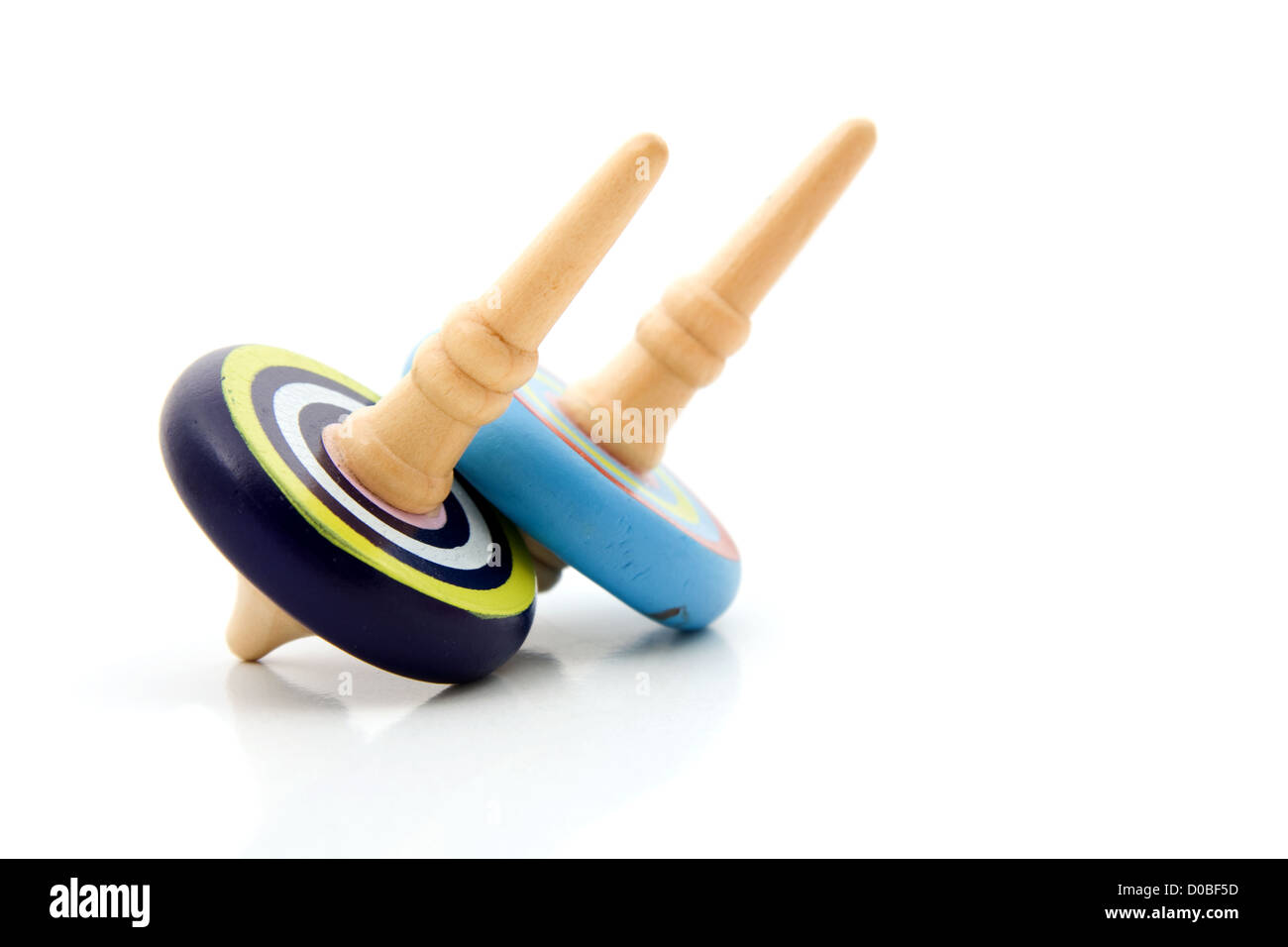 two colorful spinning tops isolated on white background Stock Photo - Alamy