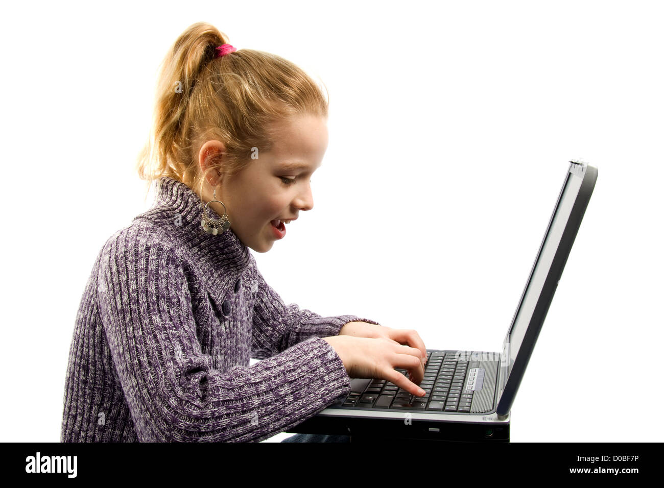 Young blonde girl is typing on laptop Stock Photo - Alamy