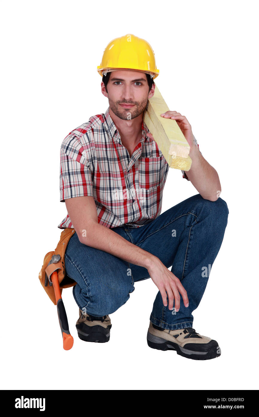 A kneeled male carpenter Stock Photo - Alamy
