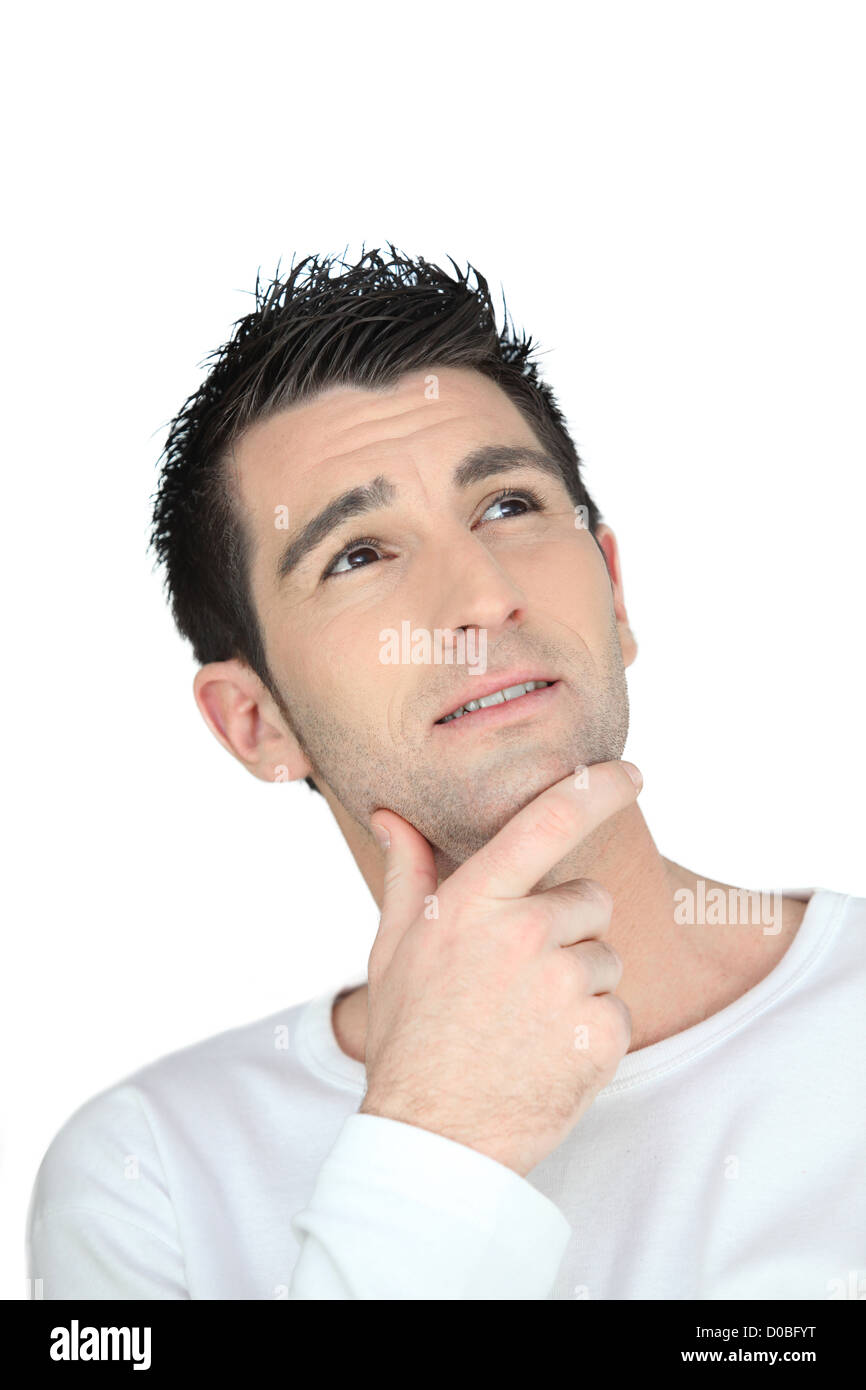 Doubtful man on white background Stock Photo - Alamy