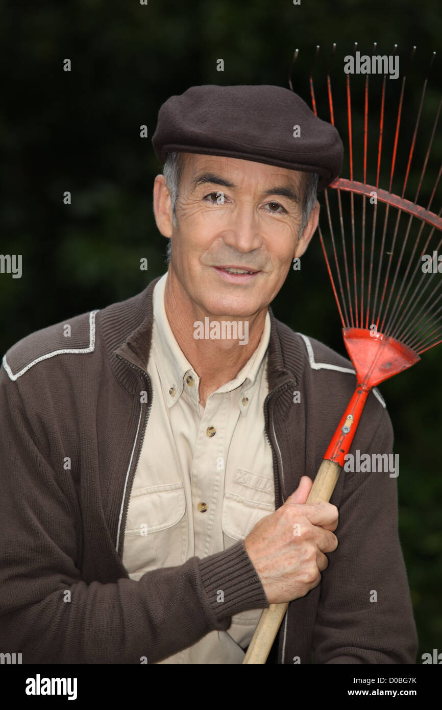 Man with rake Stock Photo - Alamy