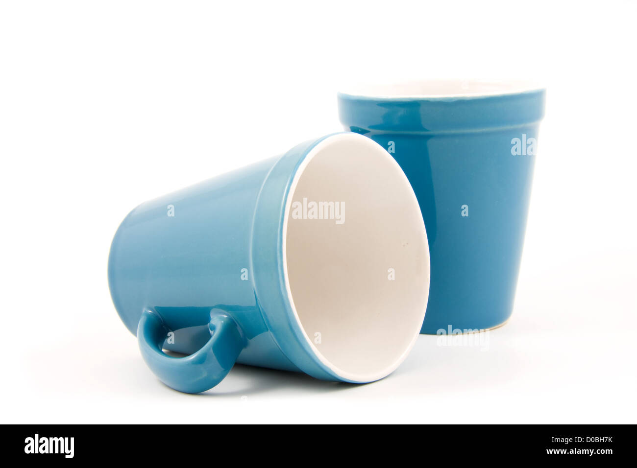 two blue coffee cups isolated on white background Stock Photo - Alamy