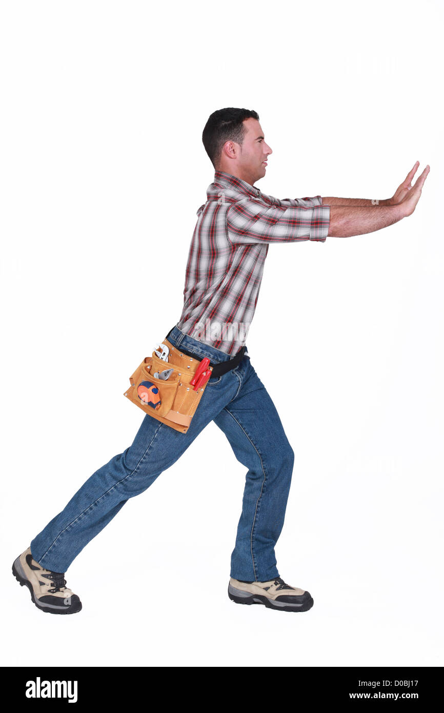 craftsman pushing something Stock Photo - Alamy