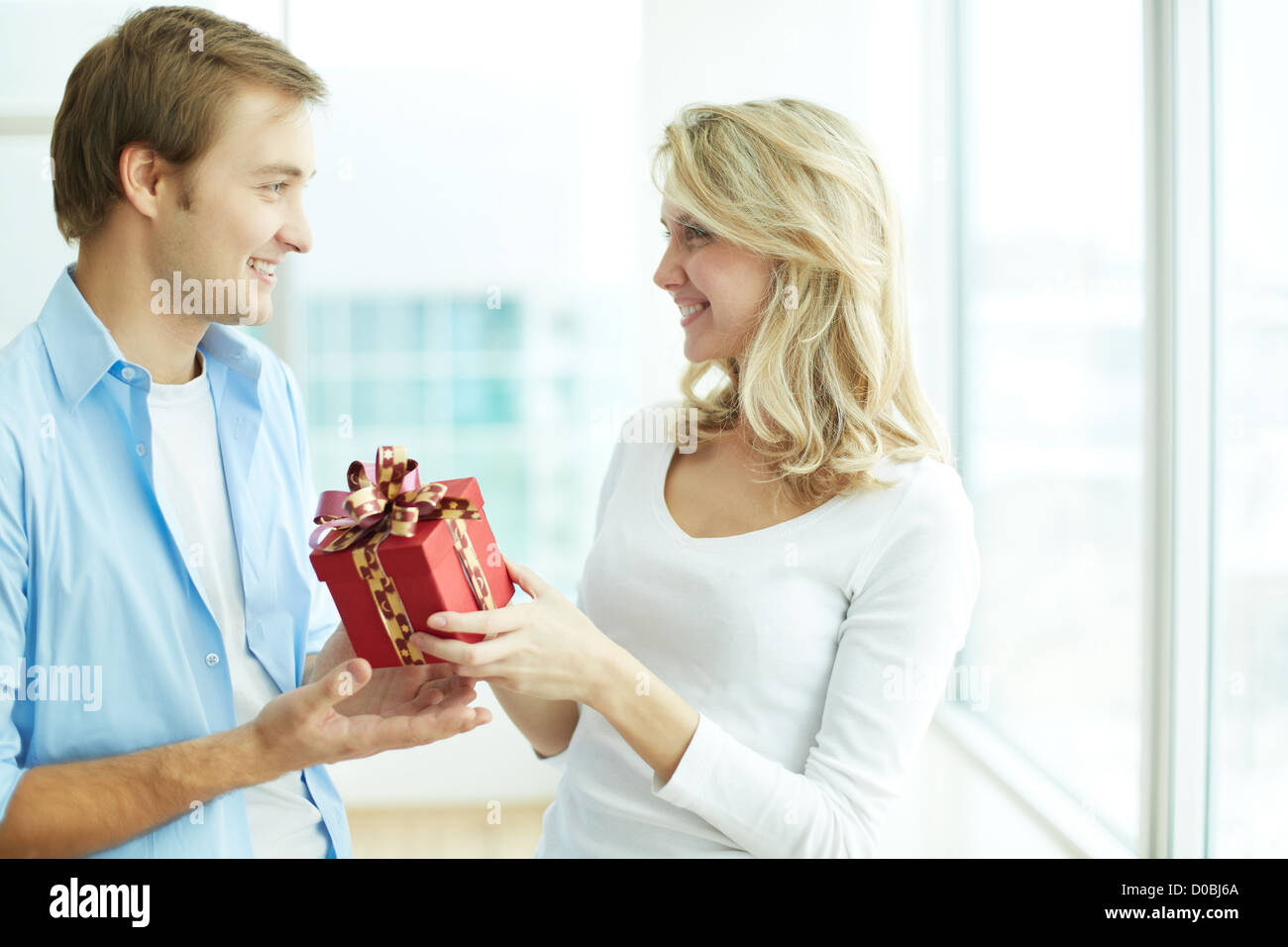 Image of young guy giving present to his girlfriend on her birthday ...