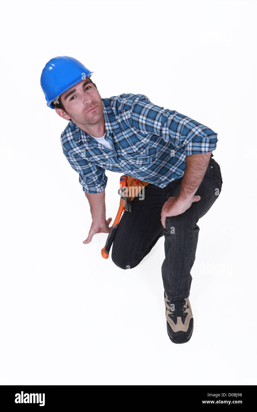 A kneeled construction worker Stock Photo - Alamy
