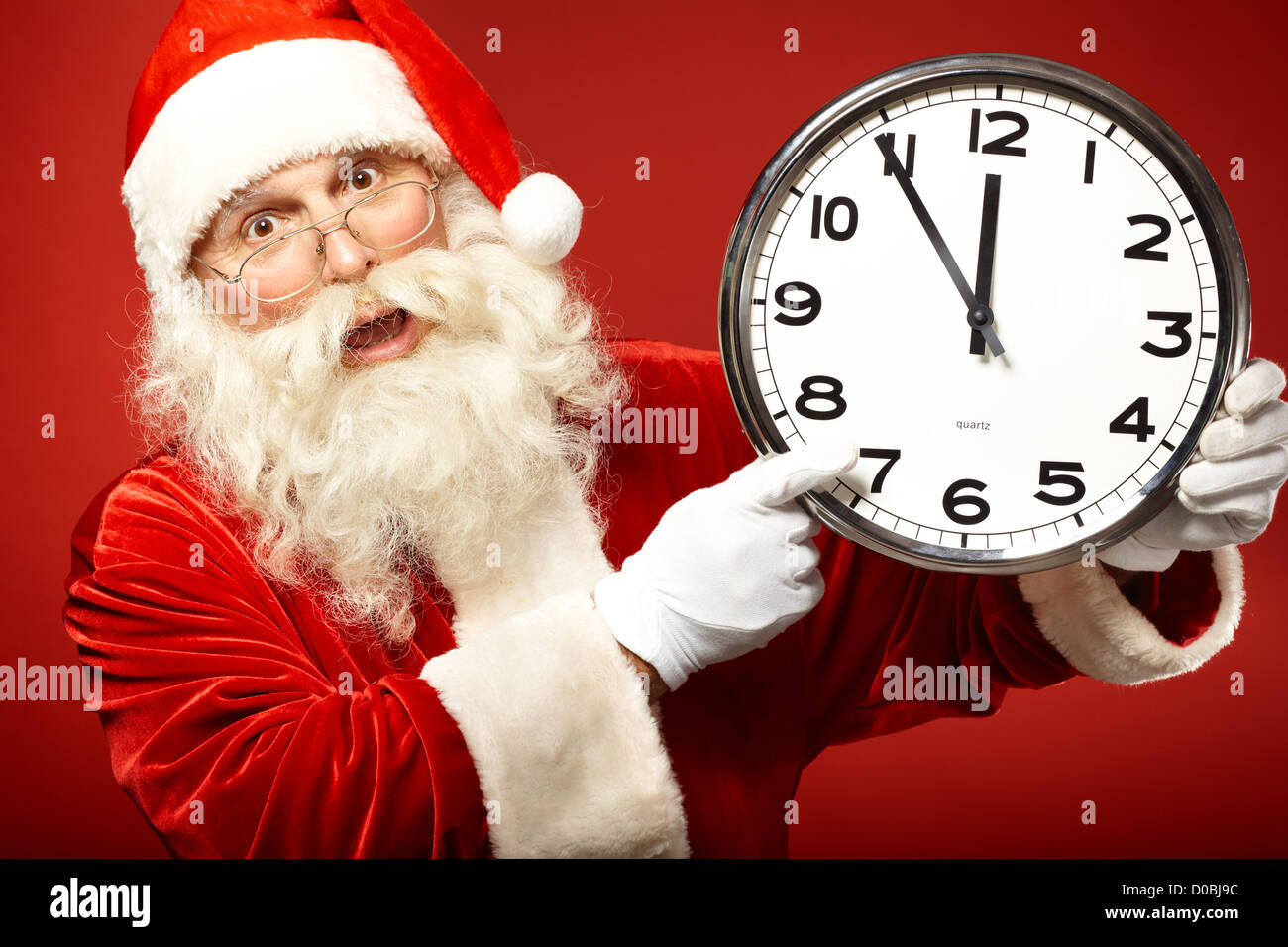 Photo of Santa holding clock showing five minutes to midnight and ...