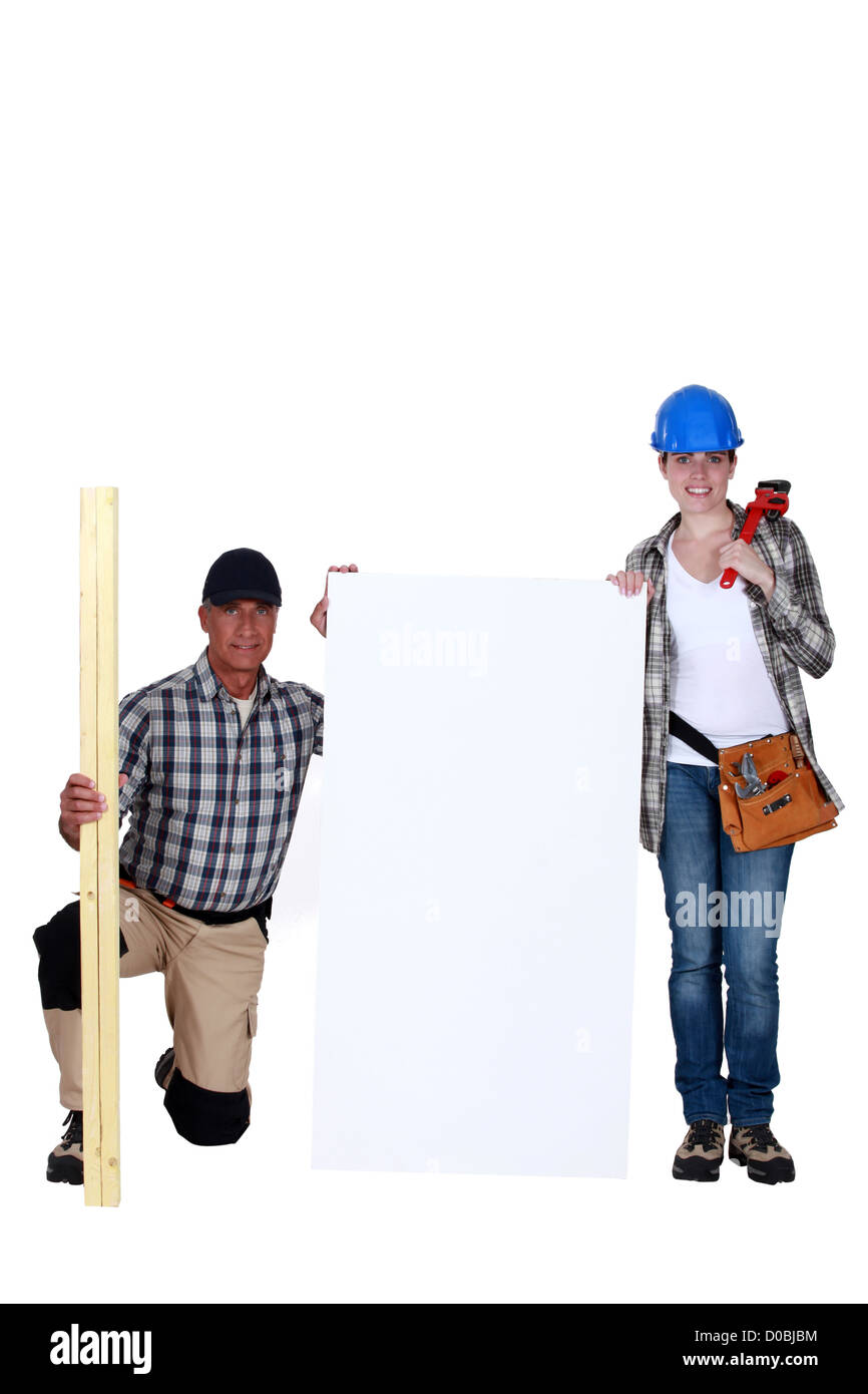 Carpenter and plumber stood with marketing board Stock Photo - Alamy