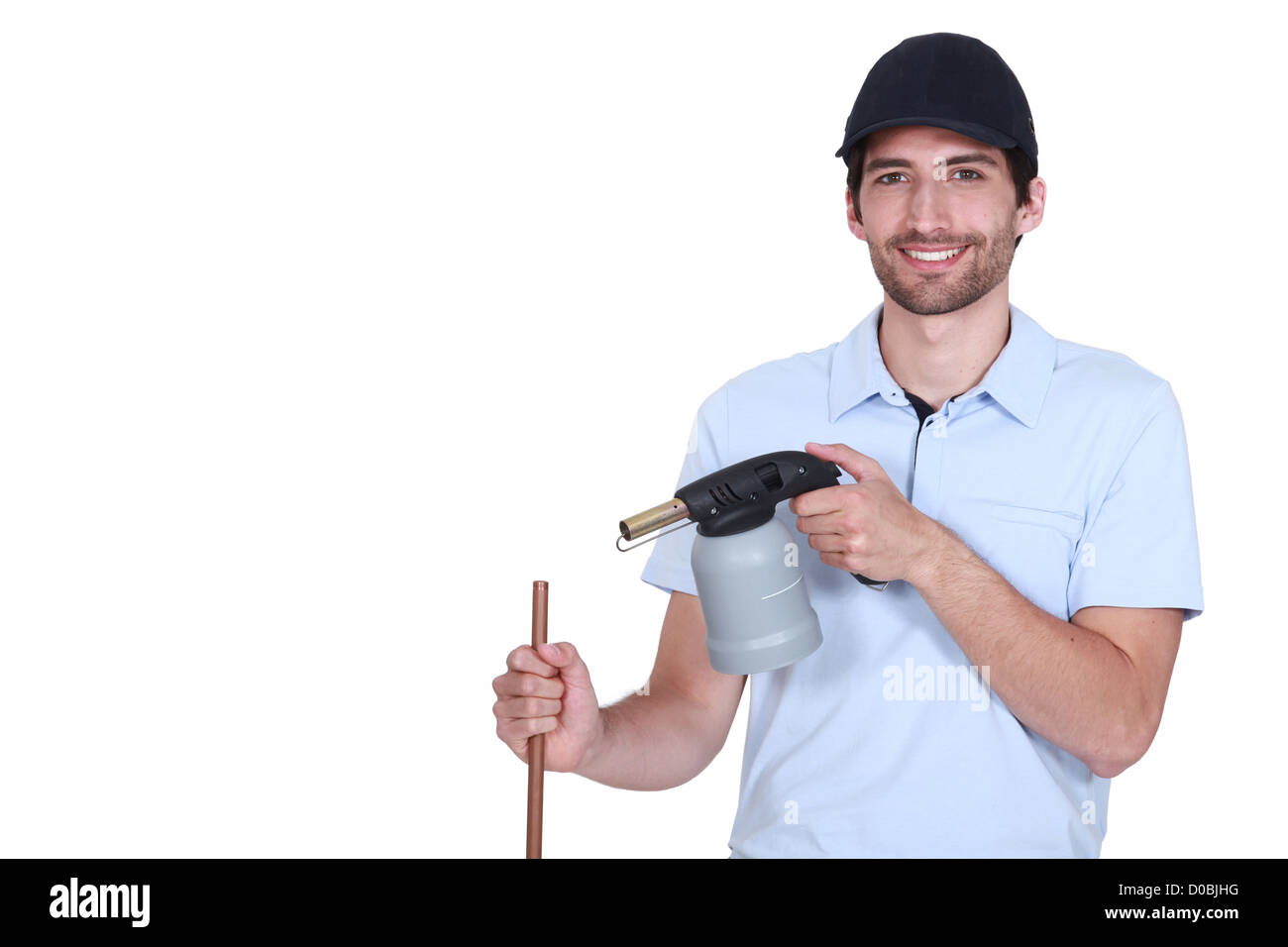 young handsome plumber at work with copper pipe and tool Stock Photo ...