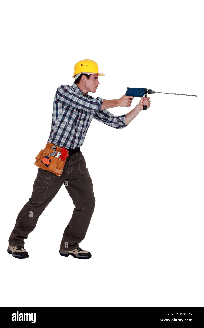 Man using drill with long bit Stock Photo - Alamy