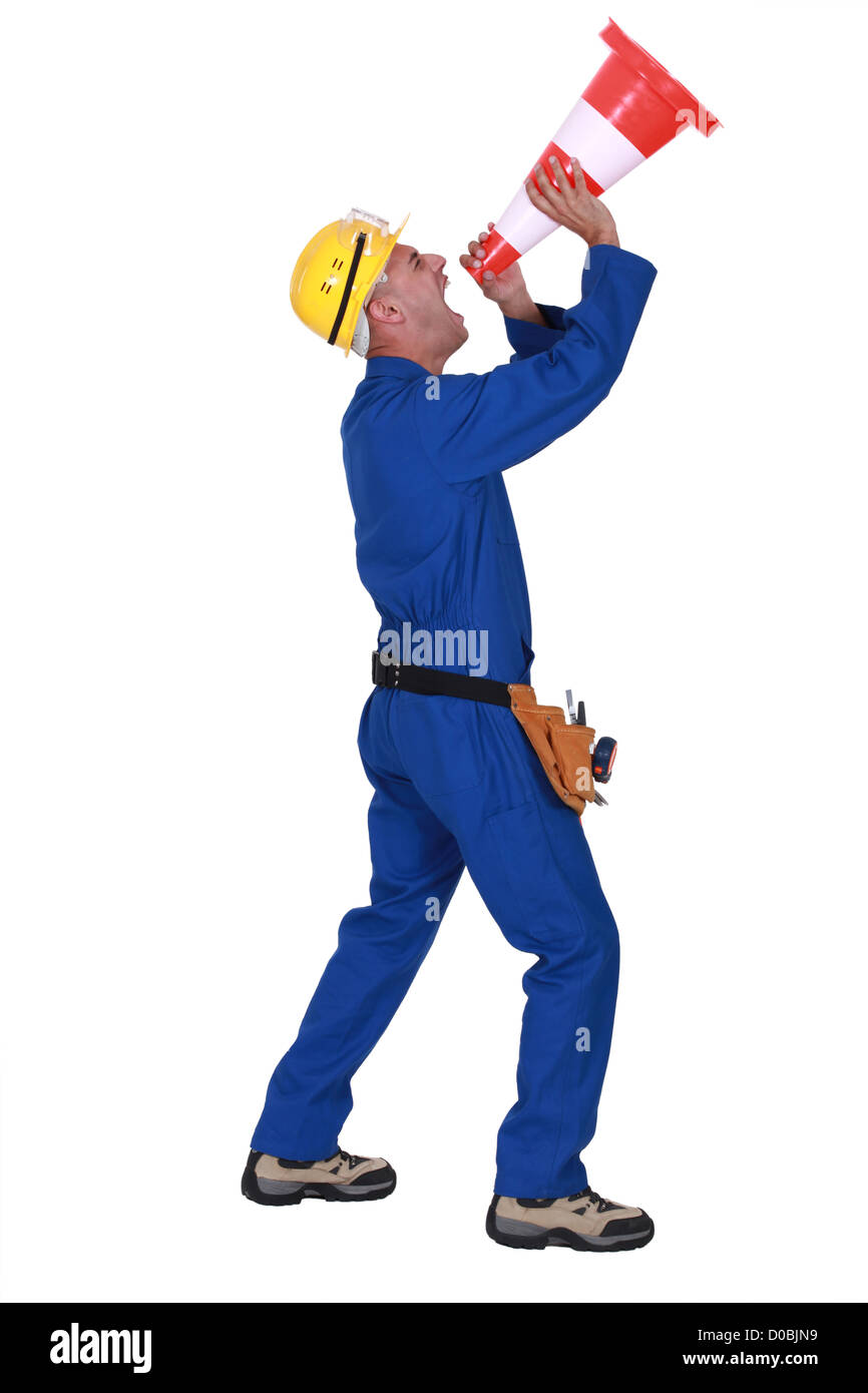 Worker shouting into traffic cone Stock Photo - Alamy