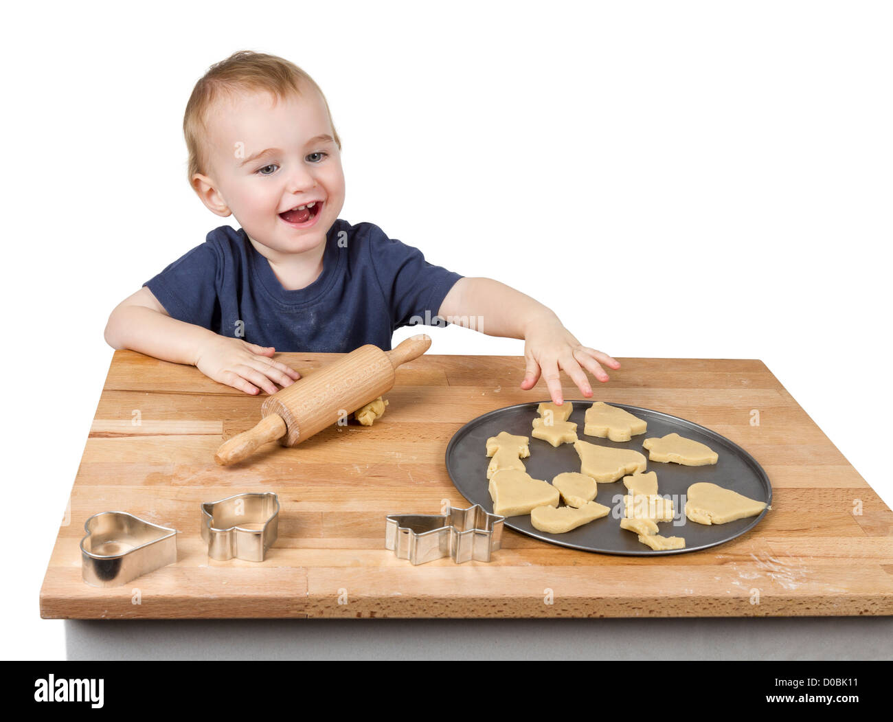 young child making cookies on small wooden desk Stock Photo - Alamy