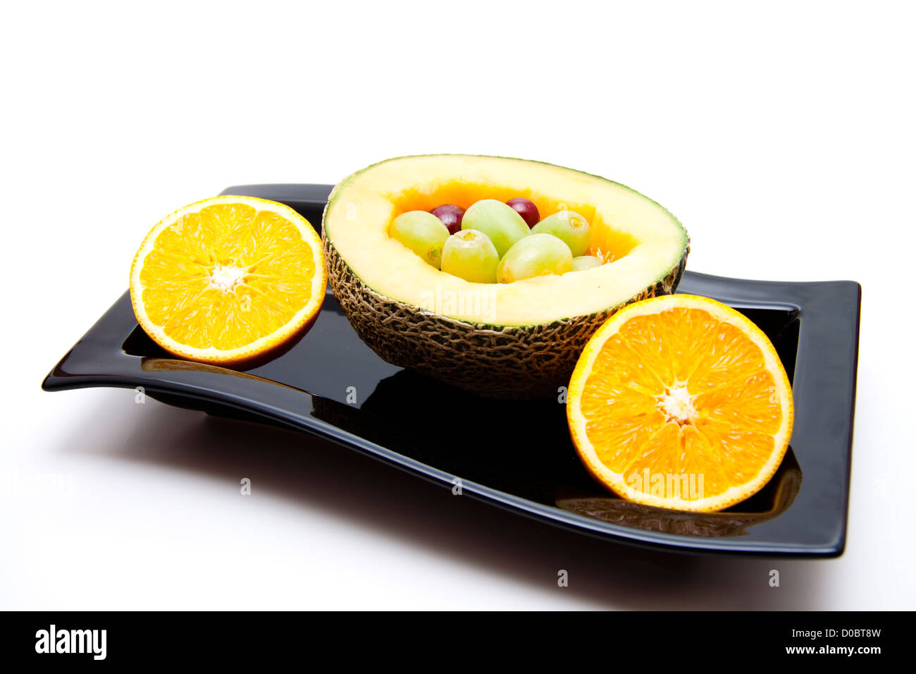 Melon with grapes and orange Stock Photo - Alamy