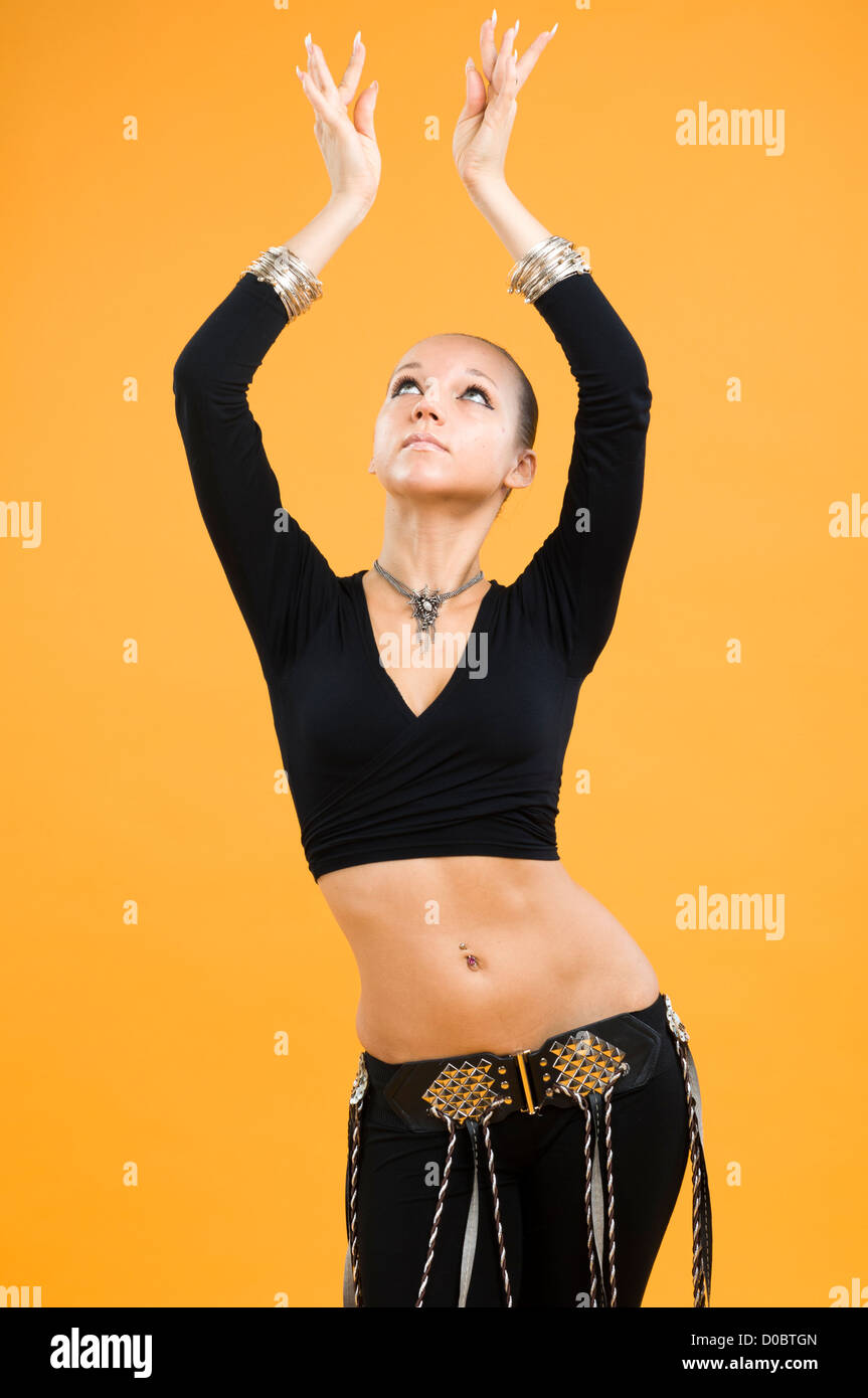 Beautiful young woman belly dancer over yellow background Stock Photo ...