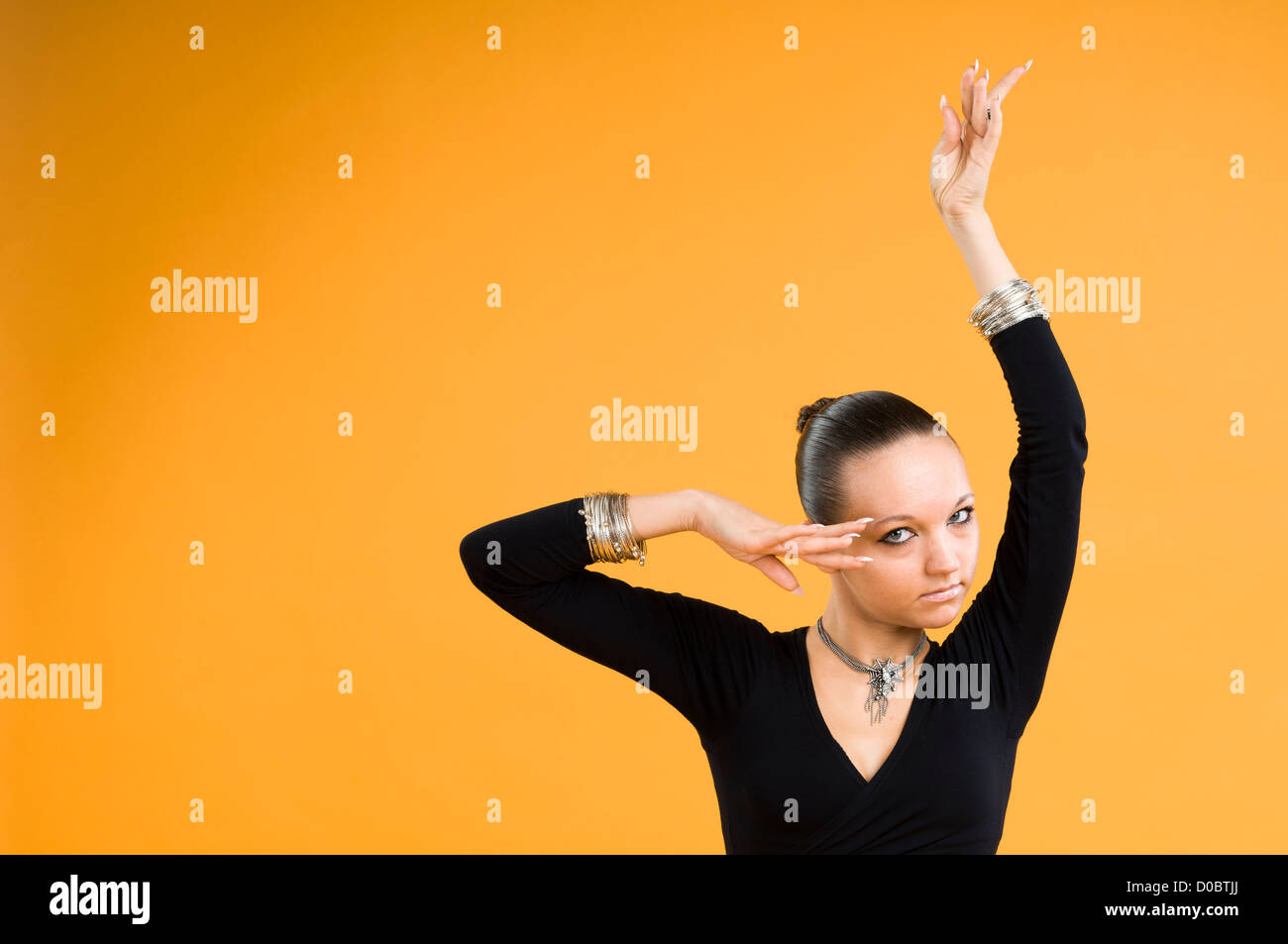 Beautiful young woman belly dancer over yellow background Stock Photo ...