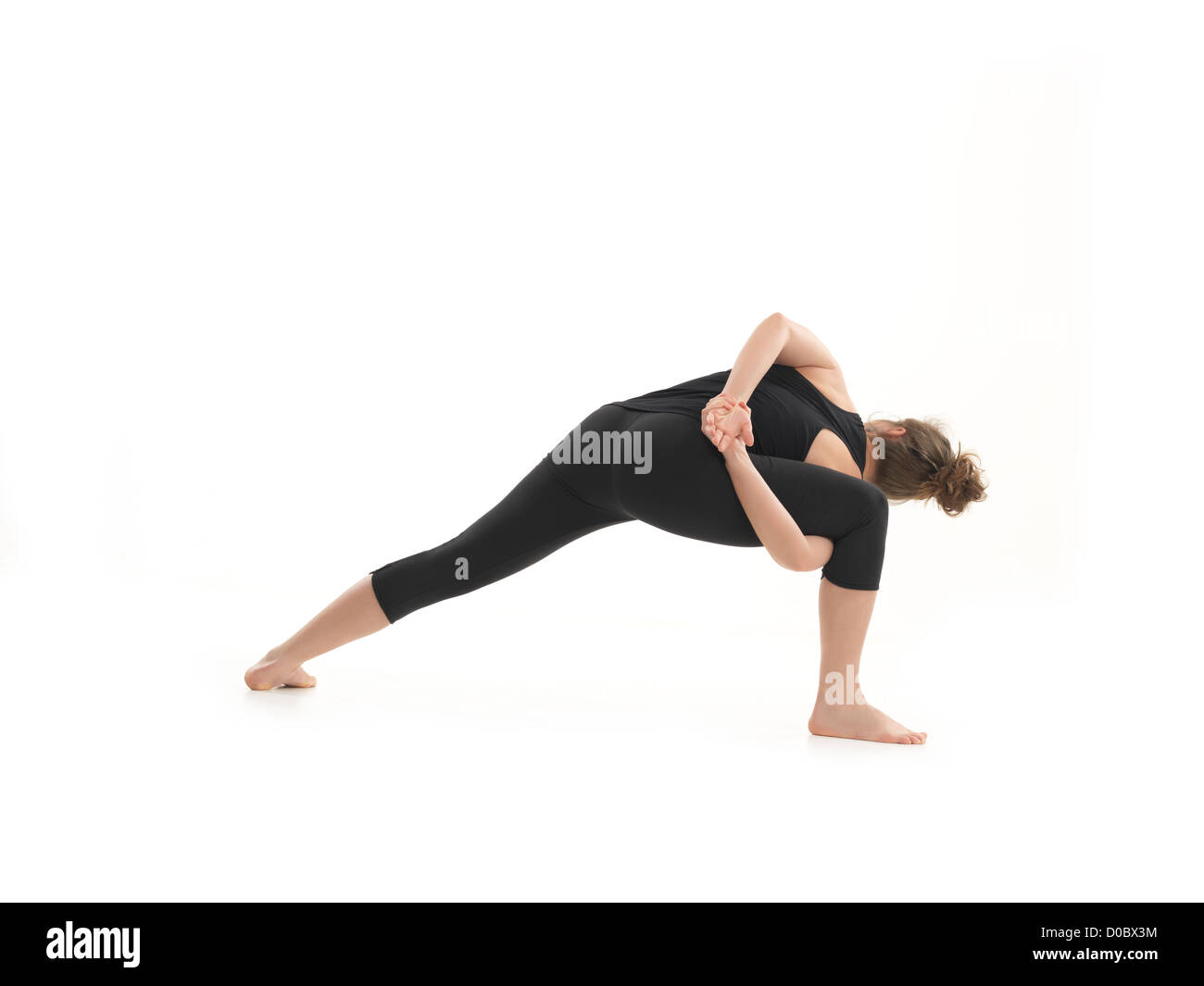 back view of adavnced balancing yoga posture, demonstrated by woman ...