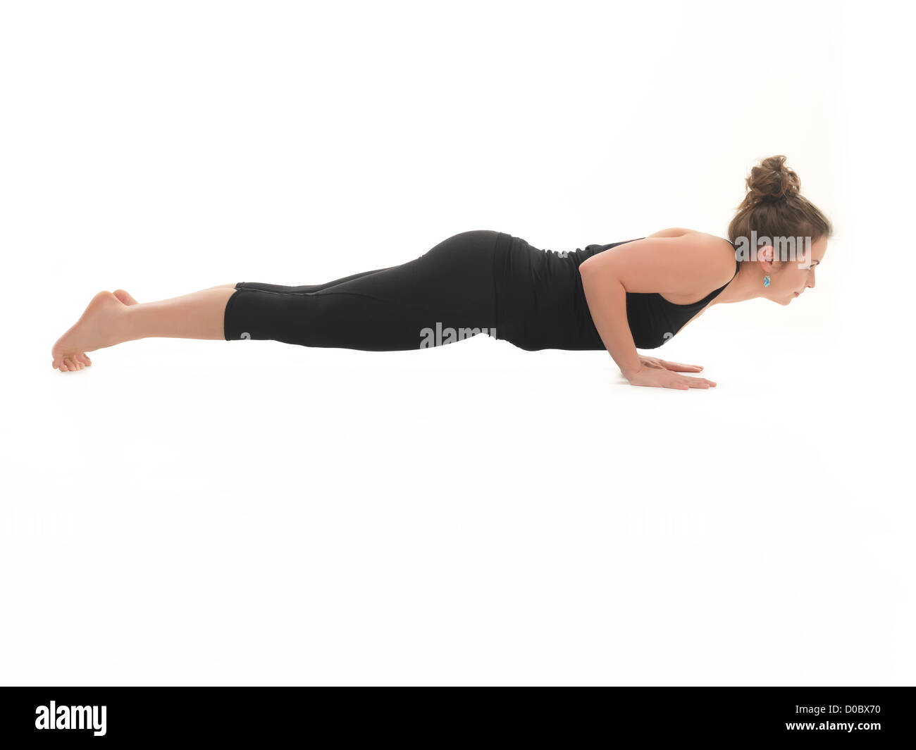 young woman in balancing yoga pose, side view, full body, dressed in ...