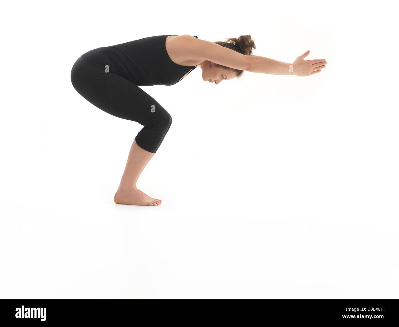side view of young woman sitting in yoga posture, dressed in balc, on ...