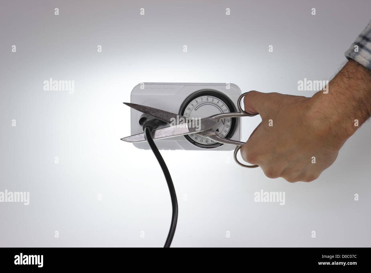 saving electricity concept, scissors and outlet timer Stock Photo - Alamy